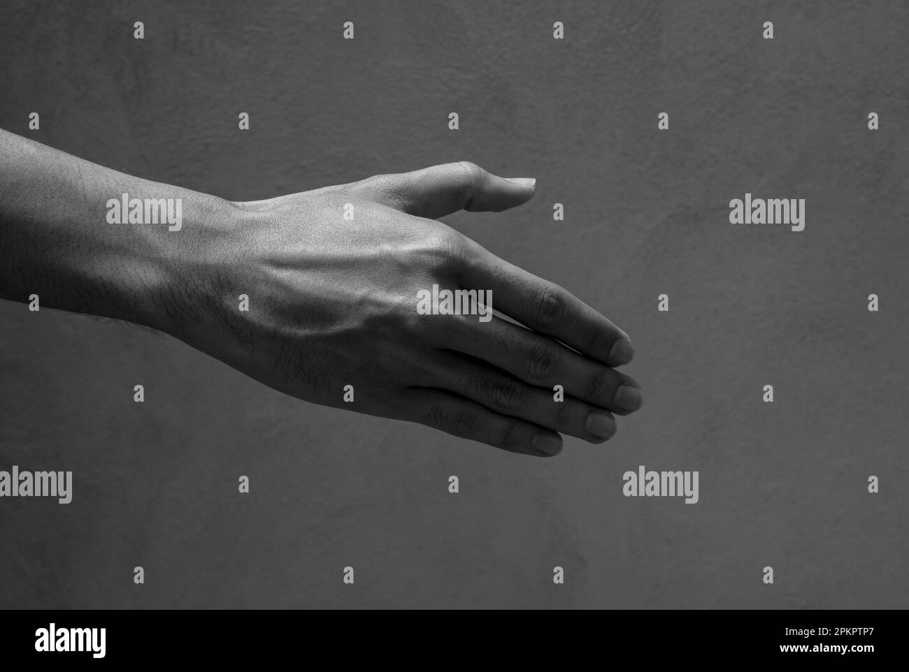 A man's right hand with shake hand gesturing with nobody, black and white style. Alone human ...