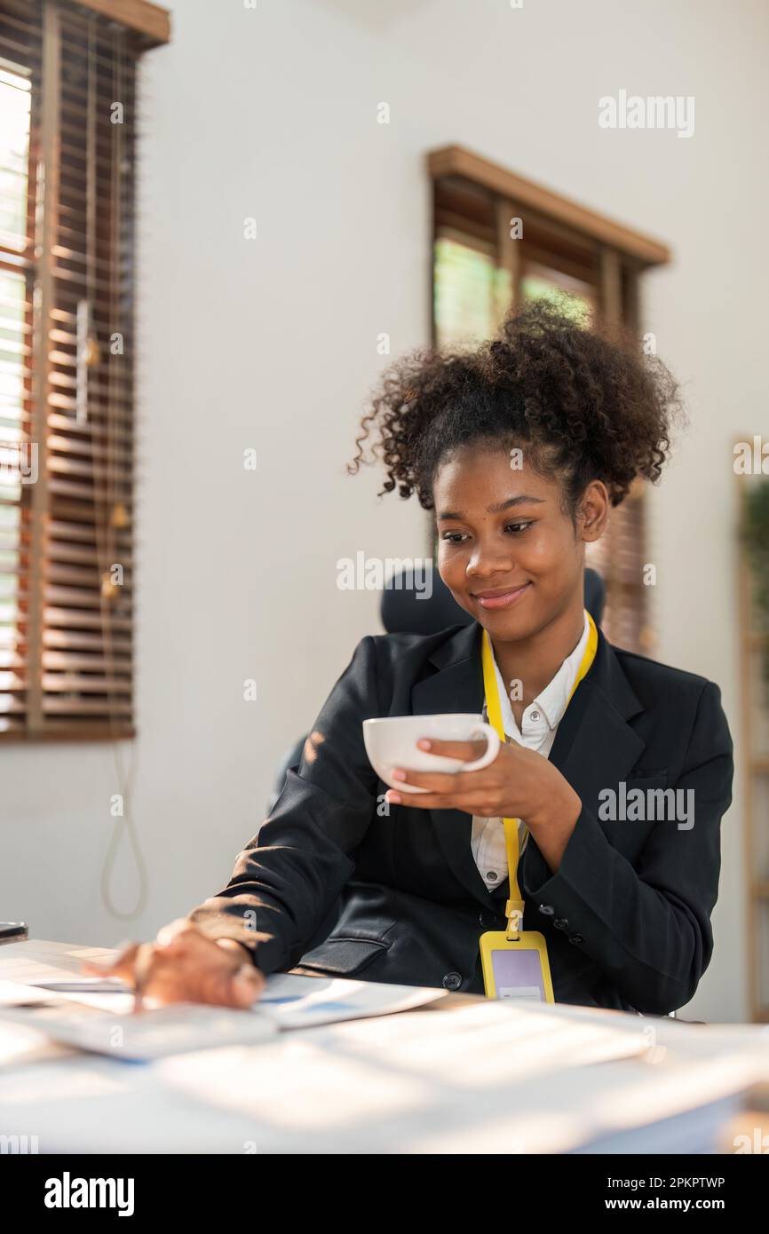 Accountant black woman working on laptop and do document, tax, exchange ...