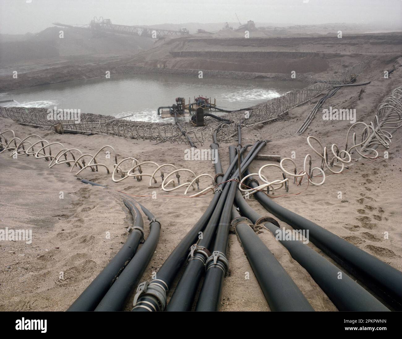 Coastal mist from the Atlantic Ocean envelopes the huge Namdeb diamand ...