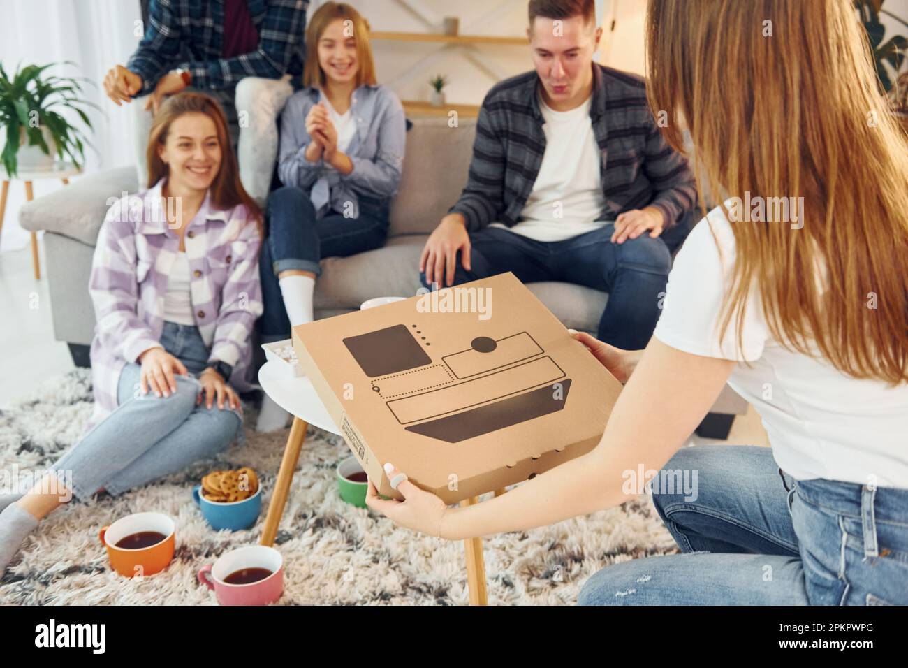 Sitting on the sofa. Group of friends have party indoors together Stock ...