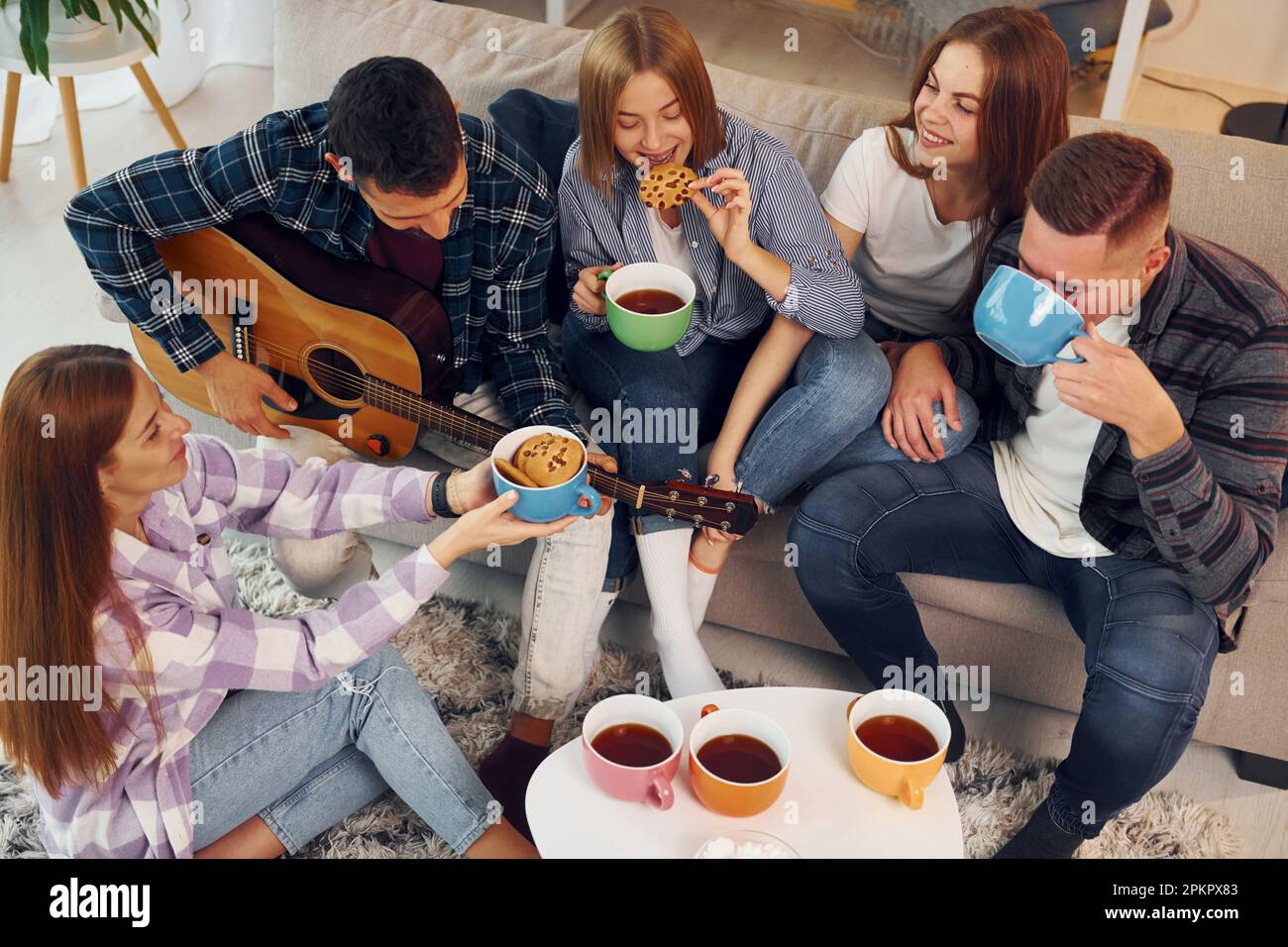 Weekend rest. Group of friends have party indoors together Stock Photo ...