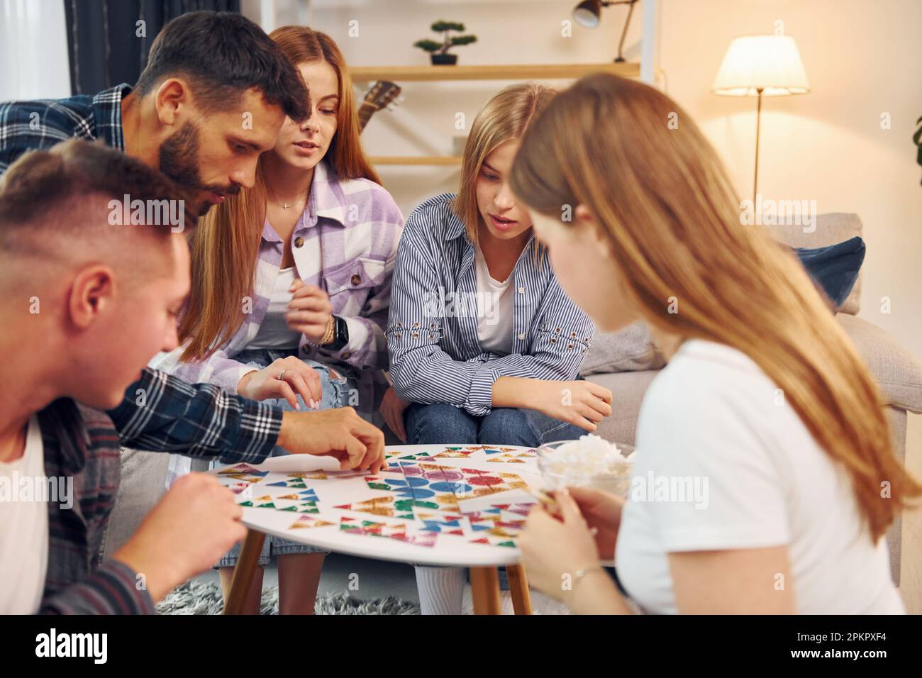 Playing smart game. Group of friends have party indoors together Stock ...