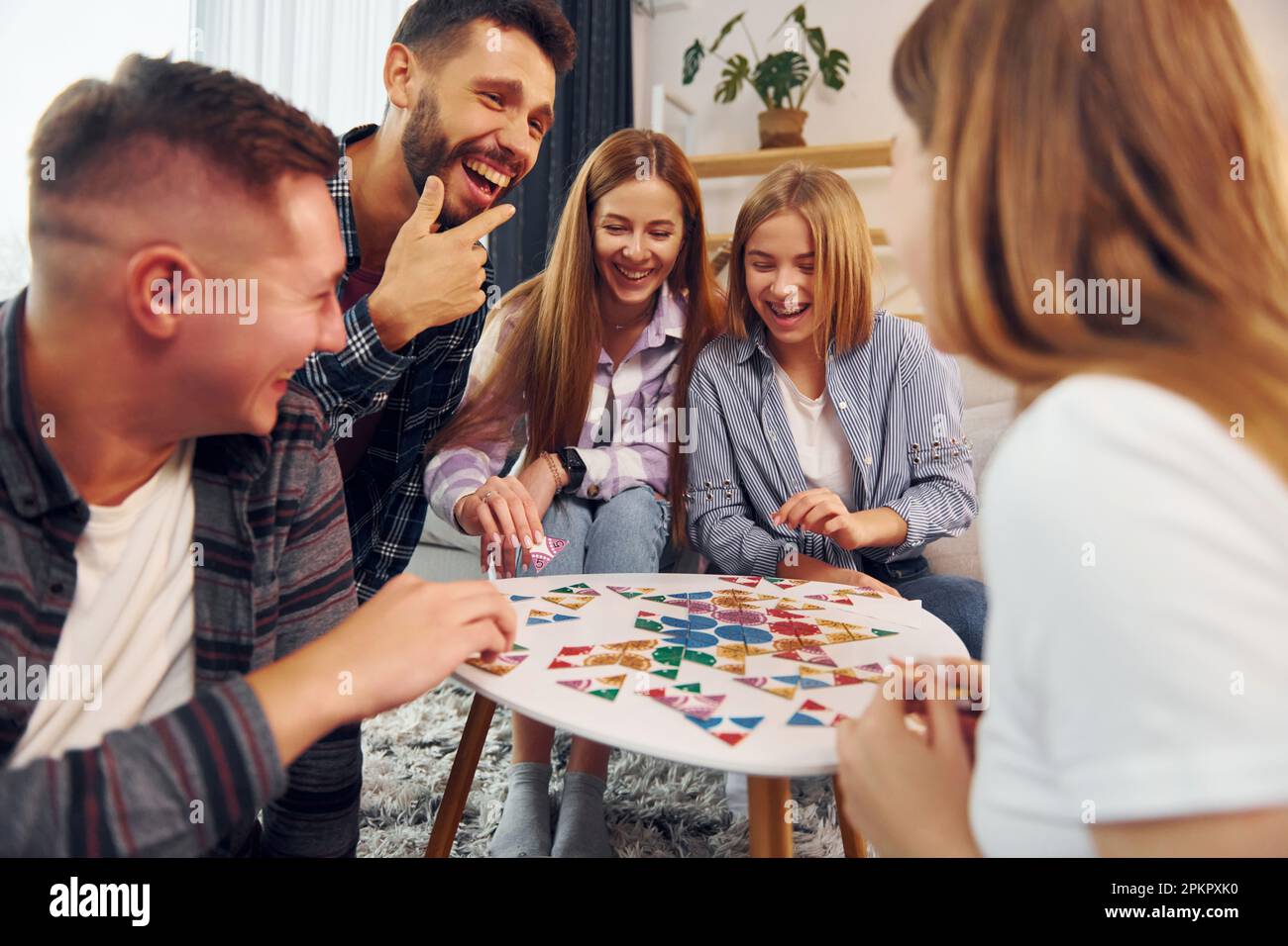 Playing smart game. Group of friends have party indoors together Stock ...