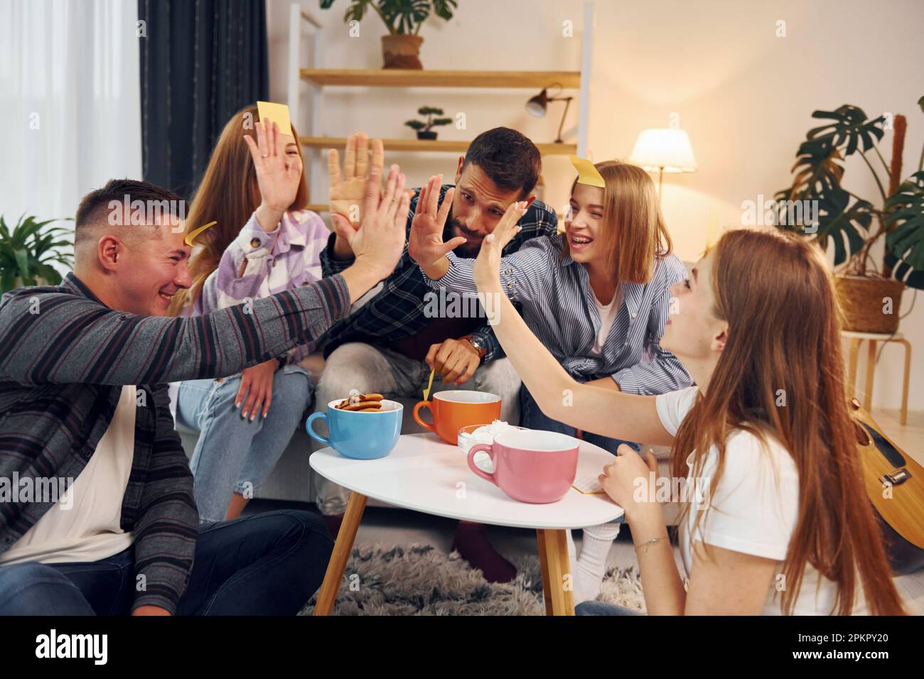 Having fun. Group of friends have party indoors together Stock Photo ...