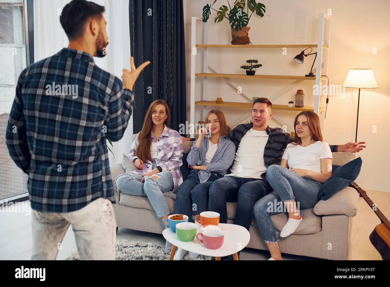 Playing game with using body language and poses. Group of friends have ...