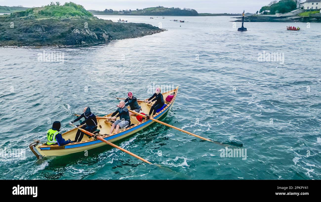 Rowers on a traditional wooden skiff rowing boat take part in a race ...