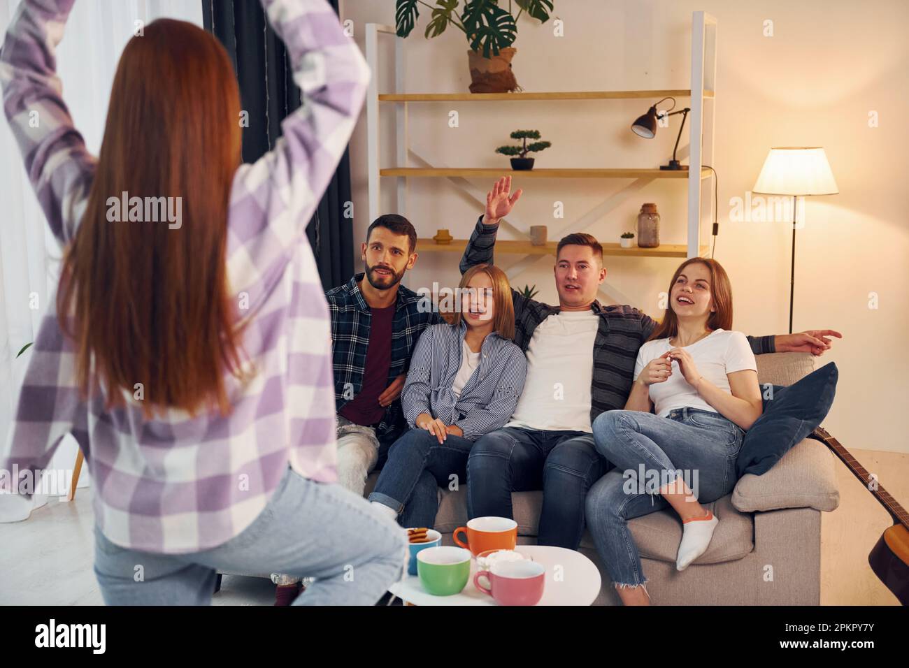 Playing game with using body language and poses. Group of friends have ...