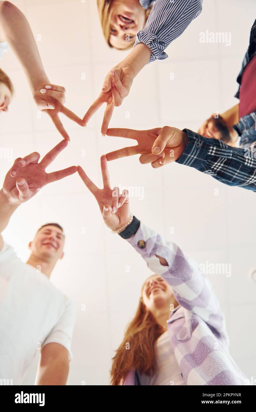 Making gesture by hands. Group of friends standing together Stock Photo ...