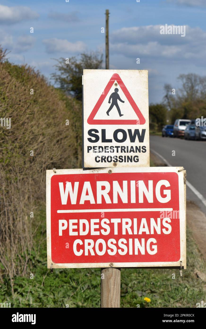 A road sign: "Warning, Slow, Pedestrians Crossing Stock Photo - Alamy