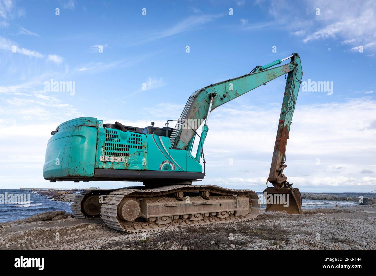 heavy machine for digging in a sea-shore Stock Photo - Alamy