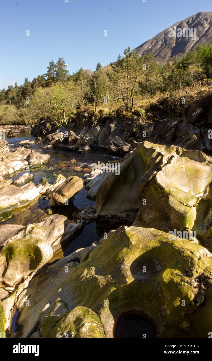 The River Coe, flowing through large volcanic boulder next to An Torr a ...