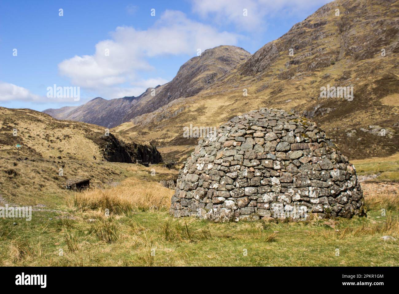 A domed Stone Cairn within the imposing mountains of Glen Coe in the ...