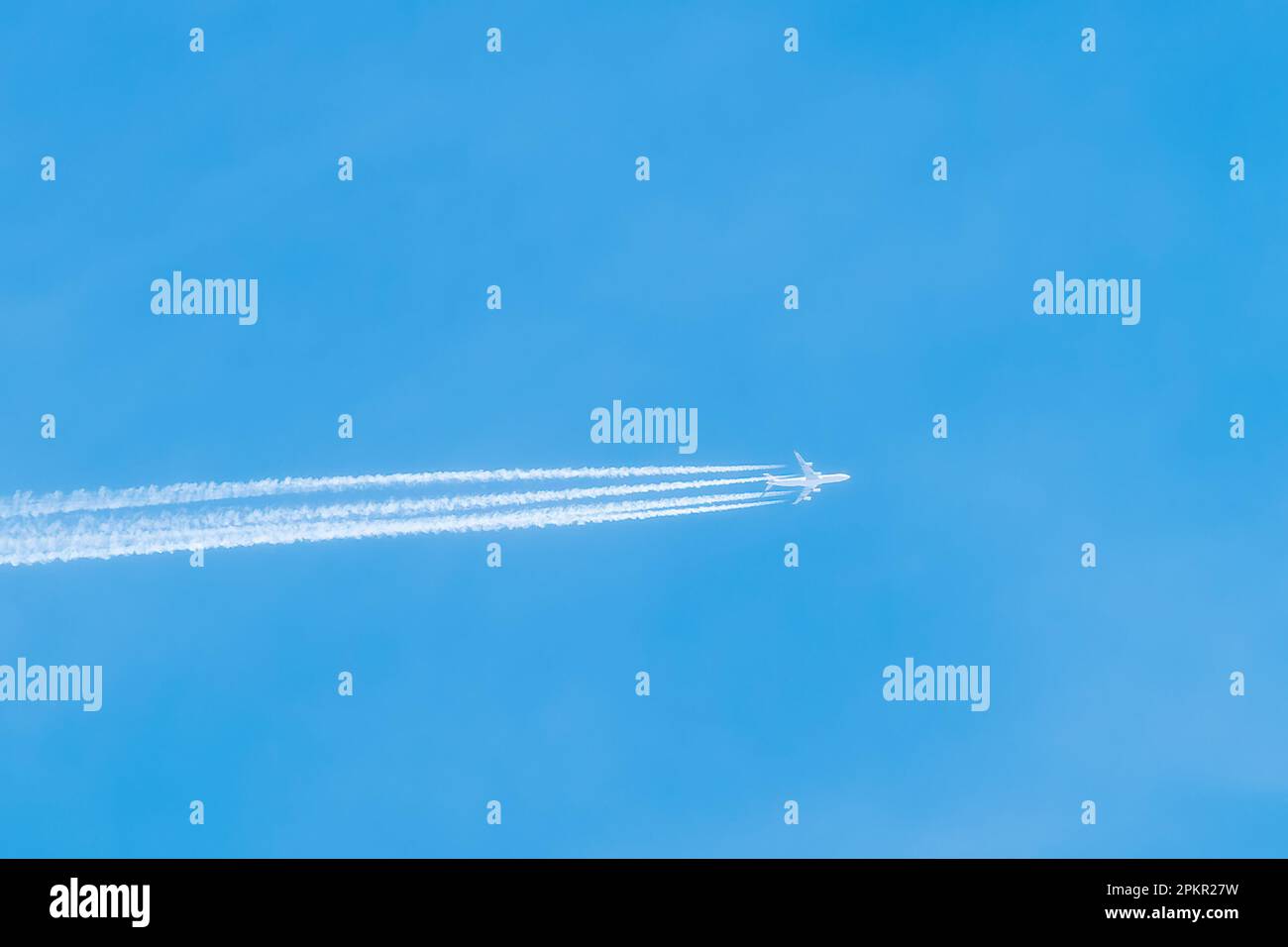 Shot of a jet plane high in the blue skies. Airliner in the blue sky ...