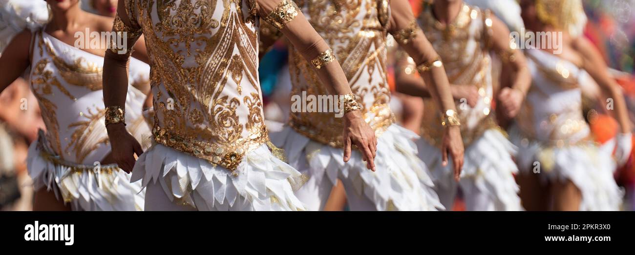 Dancing group in colourful costumes performing a traditional dance as ...