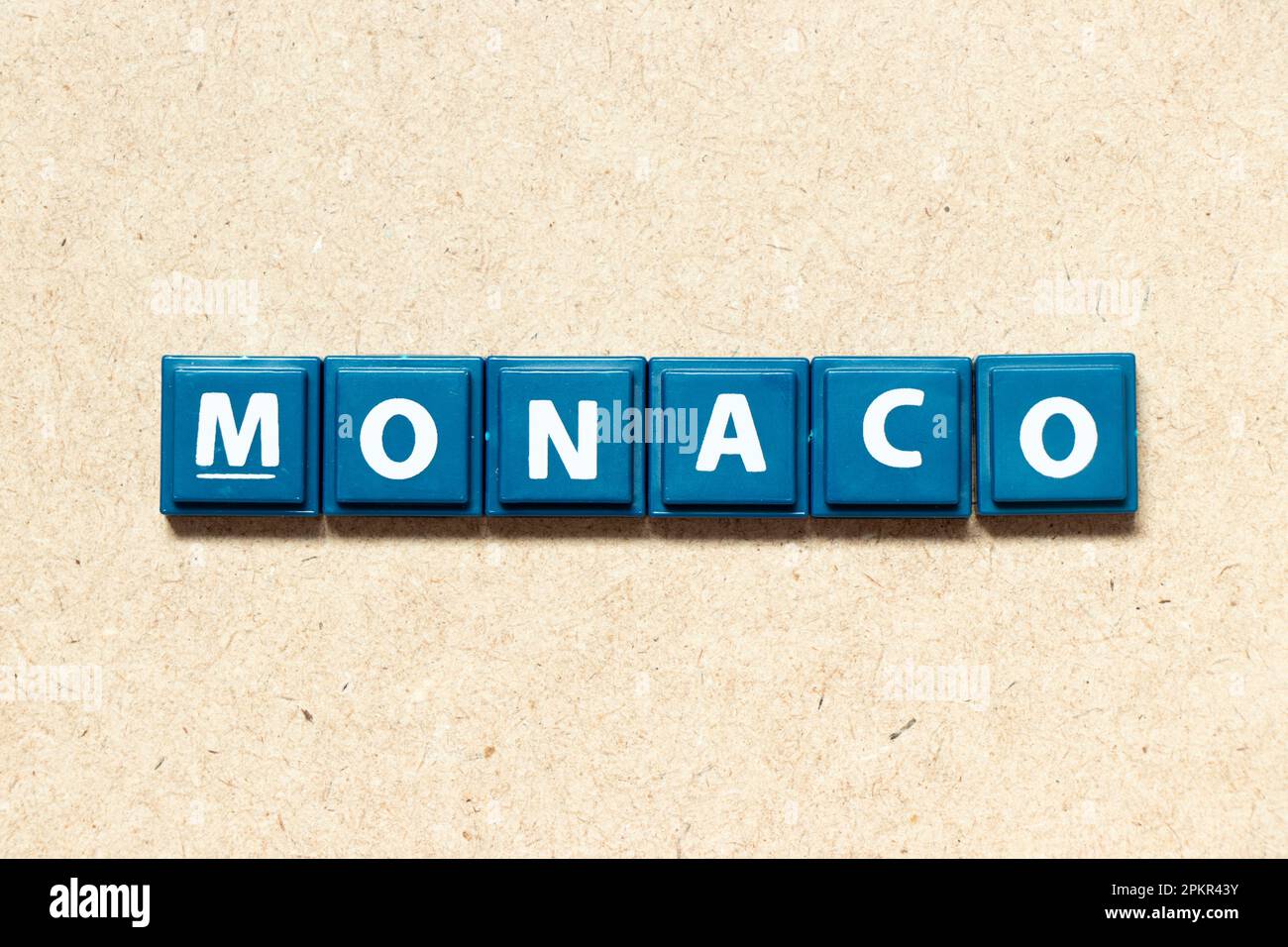 Tile alphabet letter in word monaco on wood background Stock Photo - Alamy