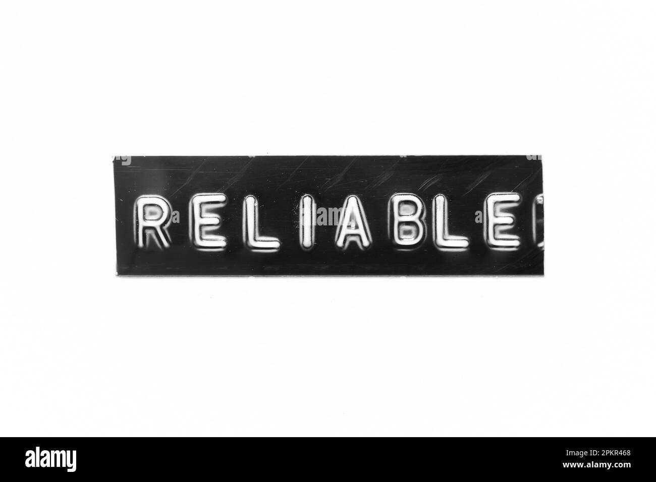 Black color banner that have embossed letter with word reliable on ...