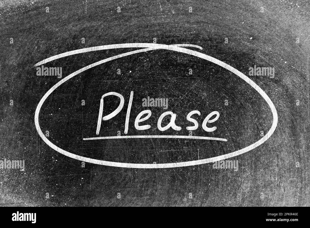 White chalk hand writing in word please and circle shape on blackboard ...