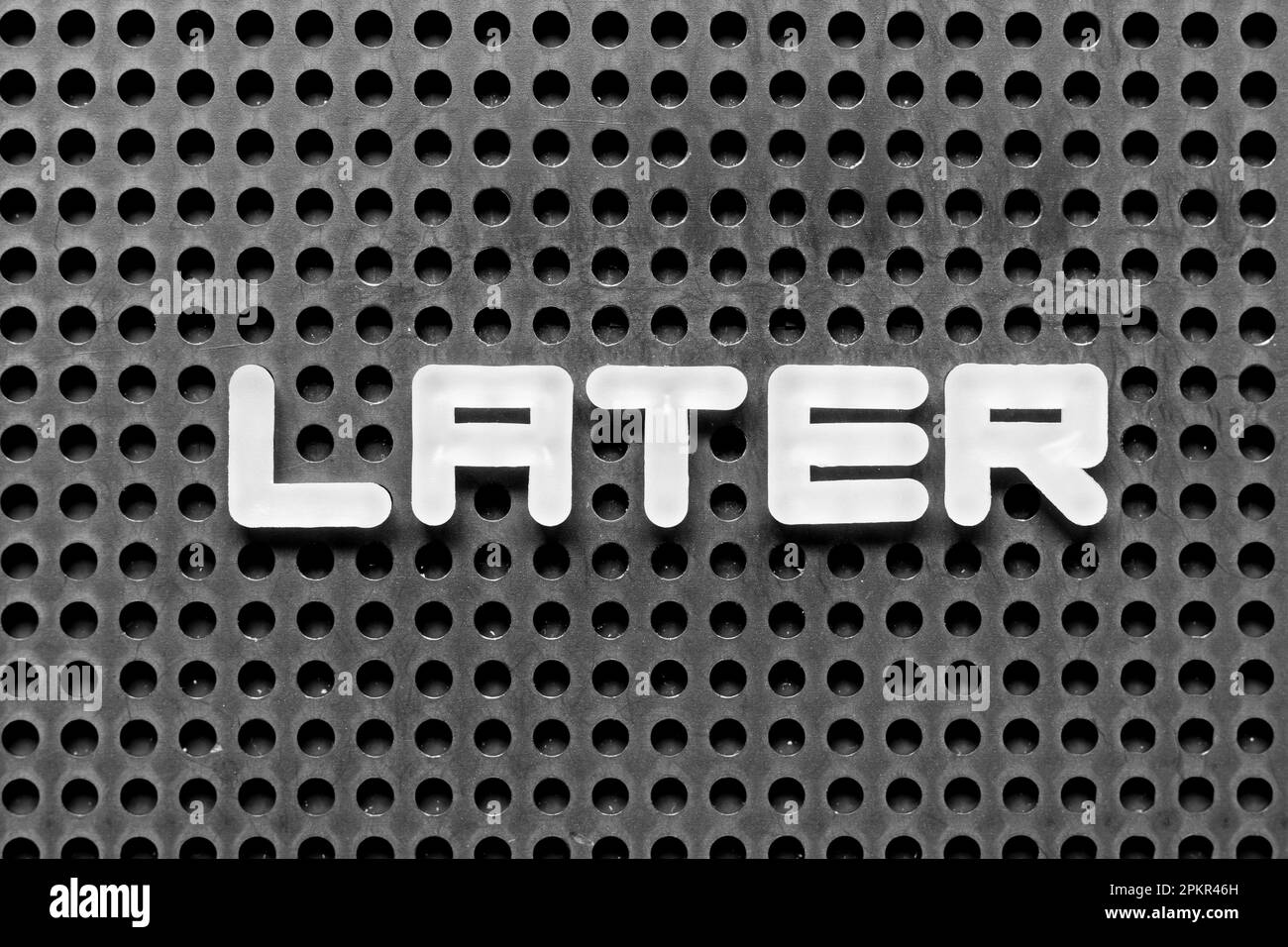 White alphabet letter in word later on black pegboard background Stock ...
