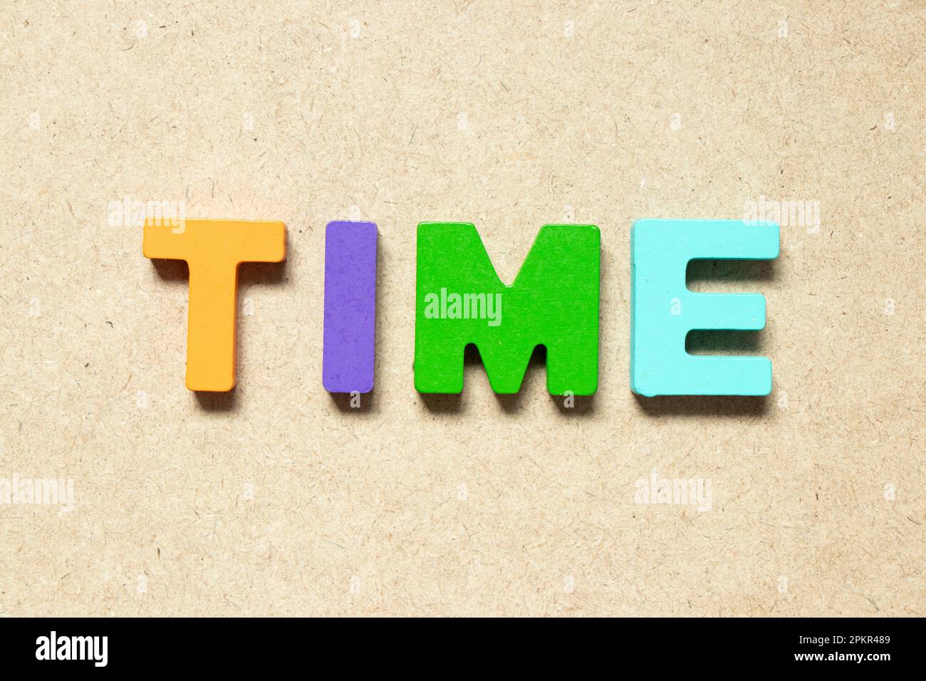 Color alphabet letter in word time on wood background Stock Photo - Alamy