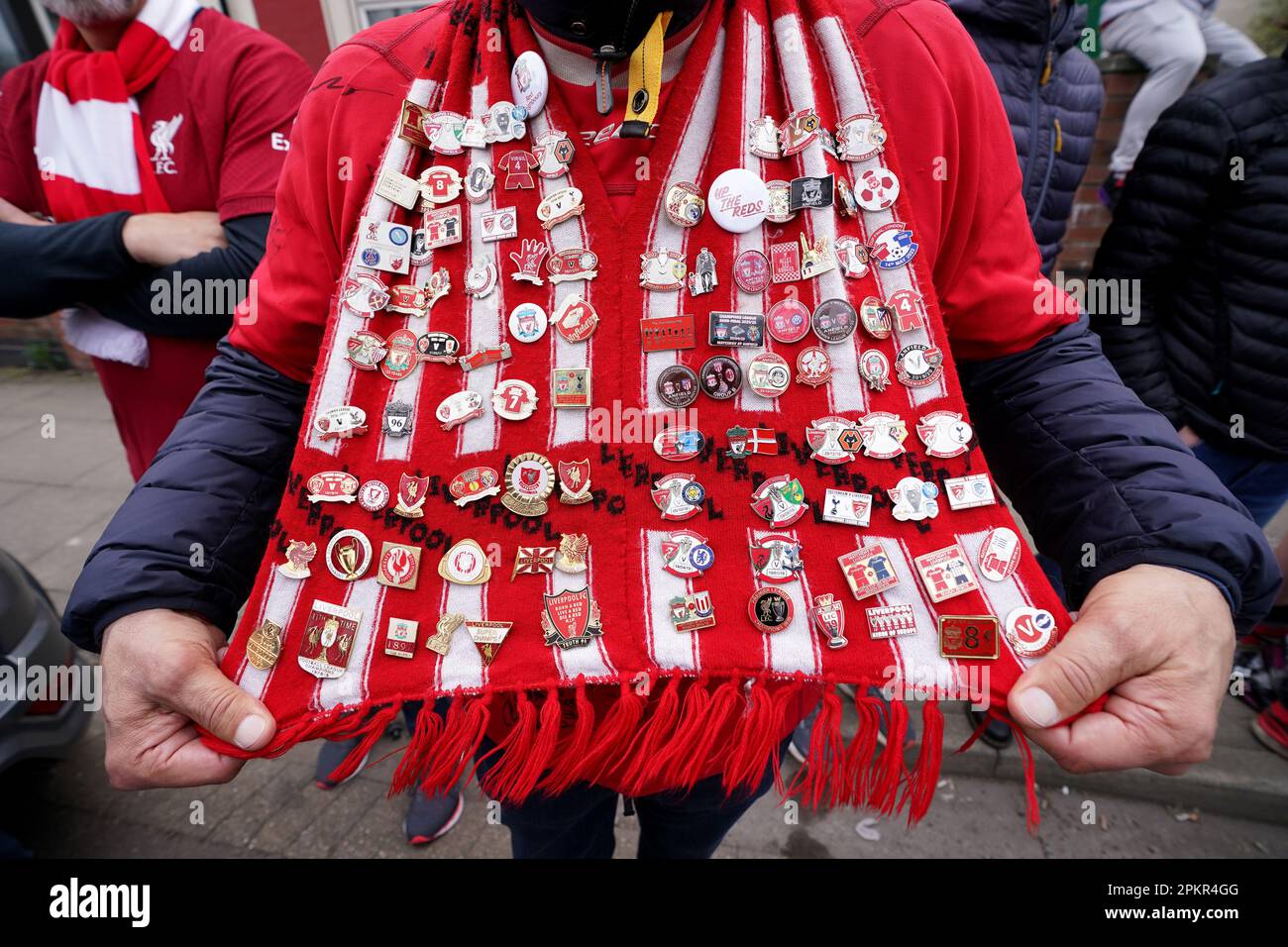 A Liverpool fan with a scarf covered in pin badges before the Premier ...