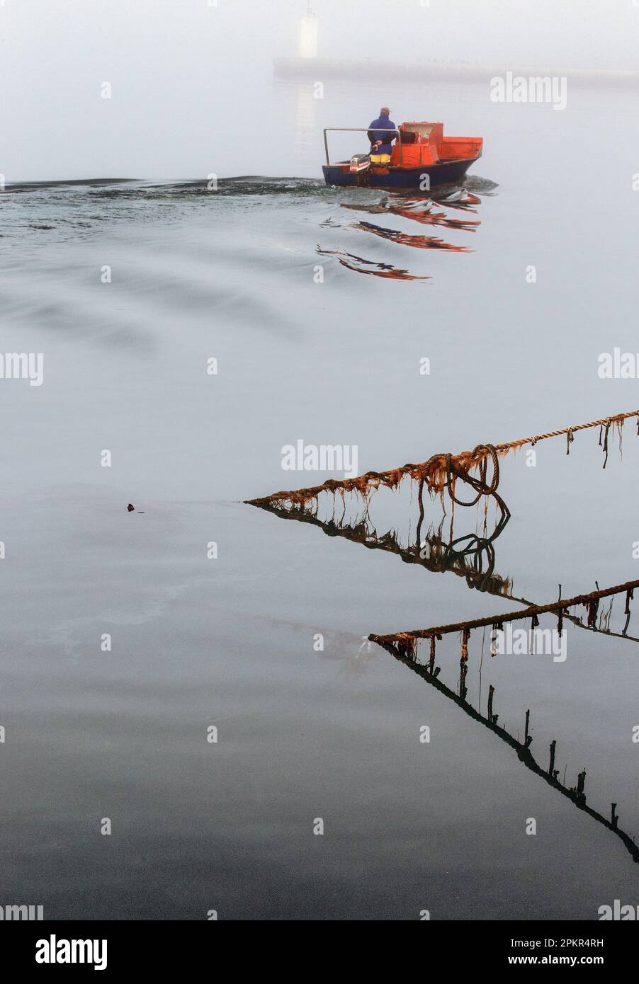 A harbour pilot boat crosses the Velddrif estuary harbour in the early ...