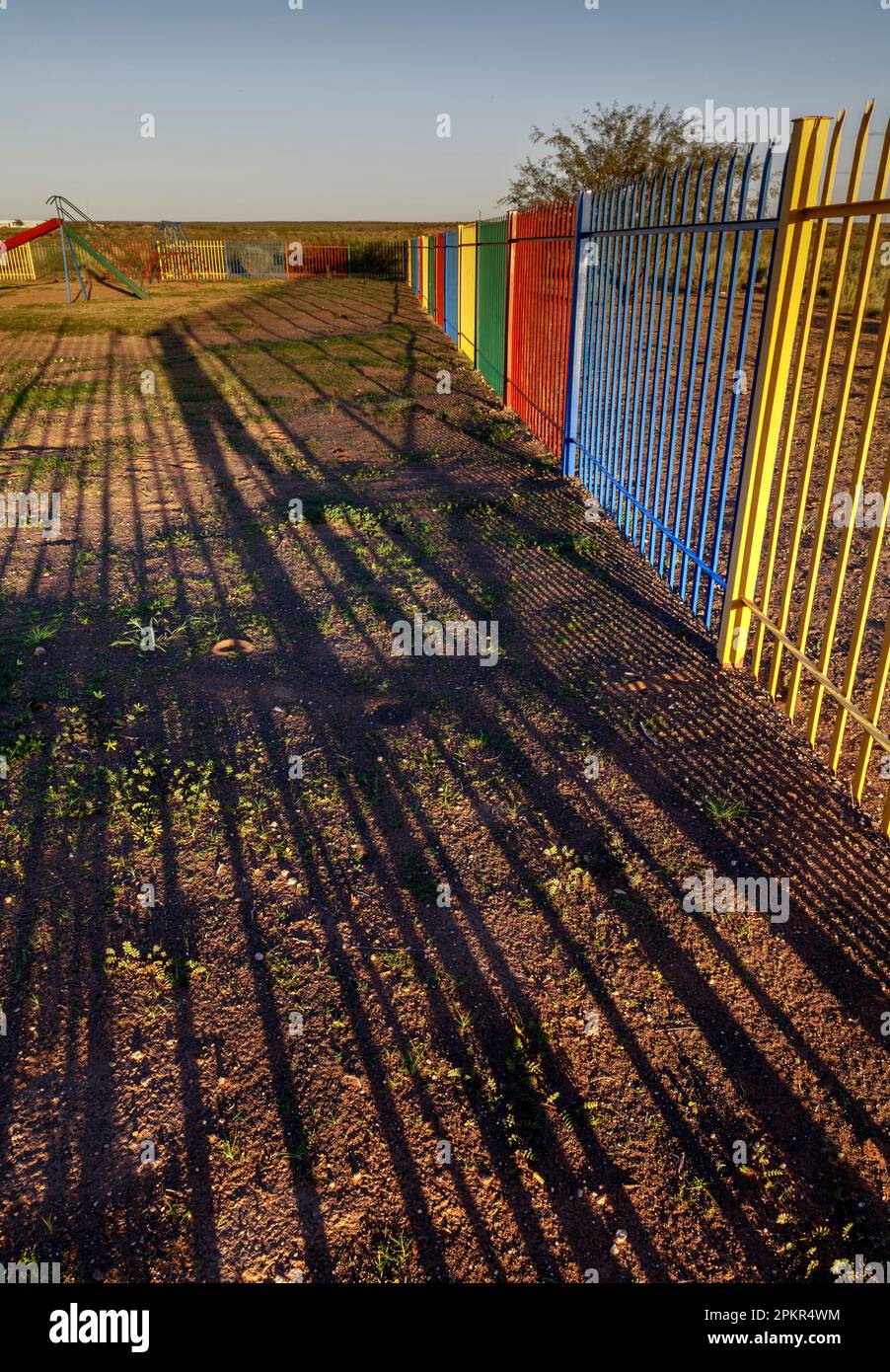 Long afternoon shadows stretch across a childrens playground in the ...