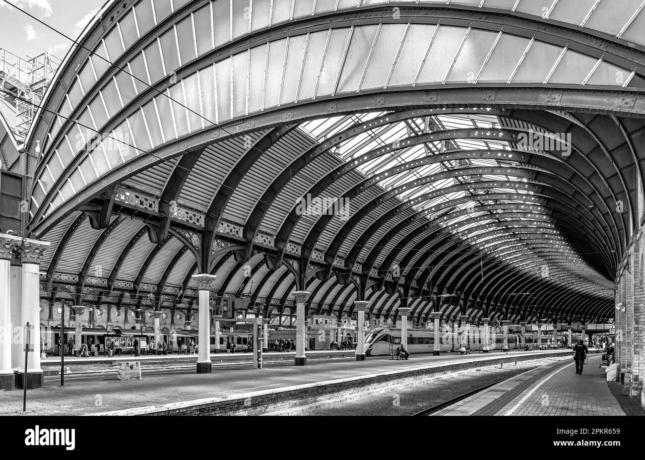 A 19th Century iron canopy, supported by columns, arches over a railway ...