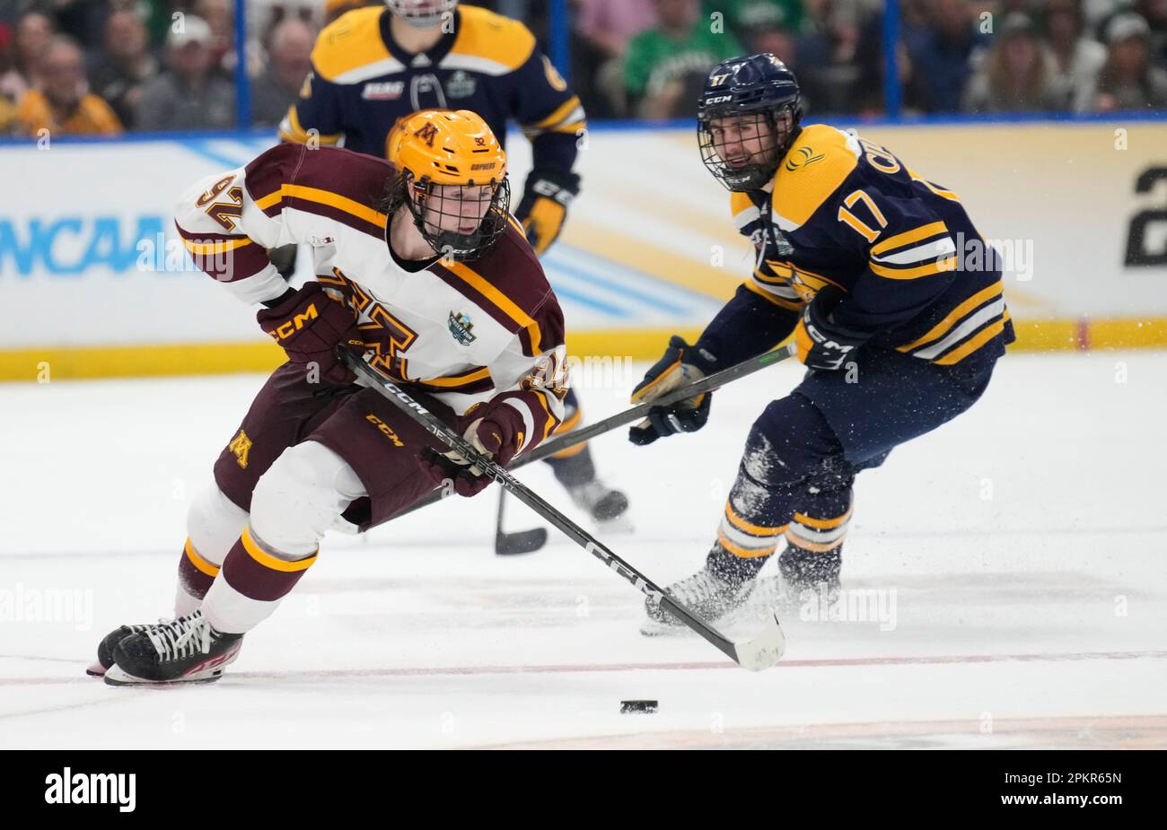 Minnesota forward Logan Cooley (92) works around Quinnipiac forward ...