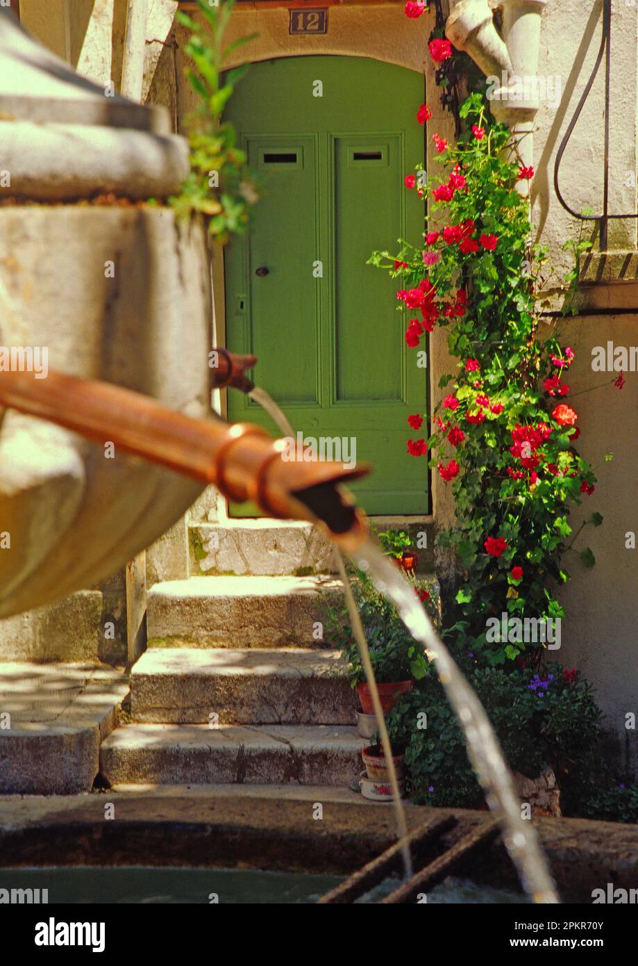 Fountain with red roses in Flayosc Provence Stock Photo - Alamy
