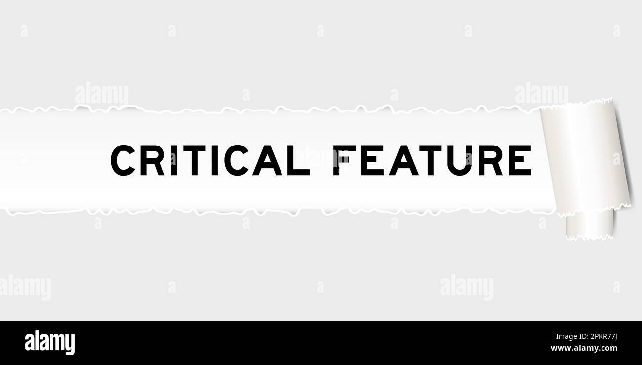 Ripped gray paper background that have word critical feature under torn ...