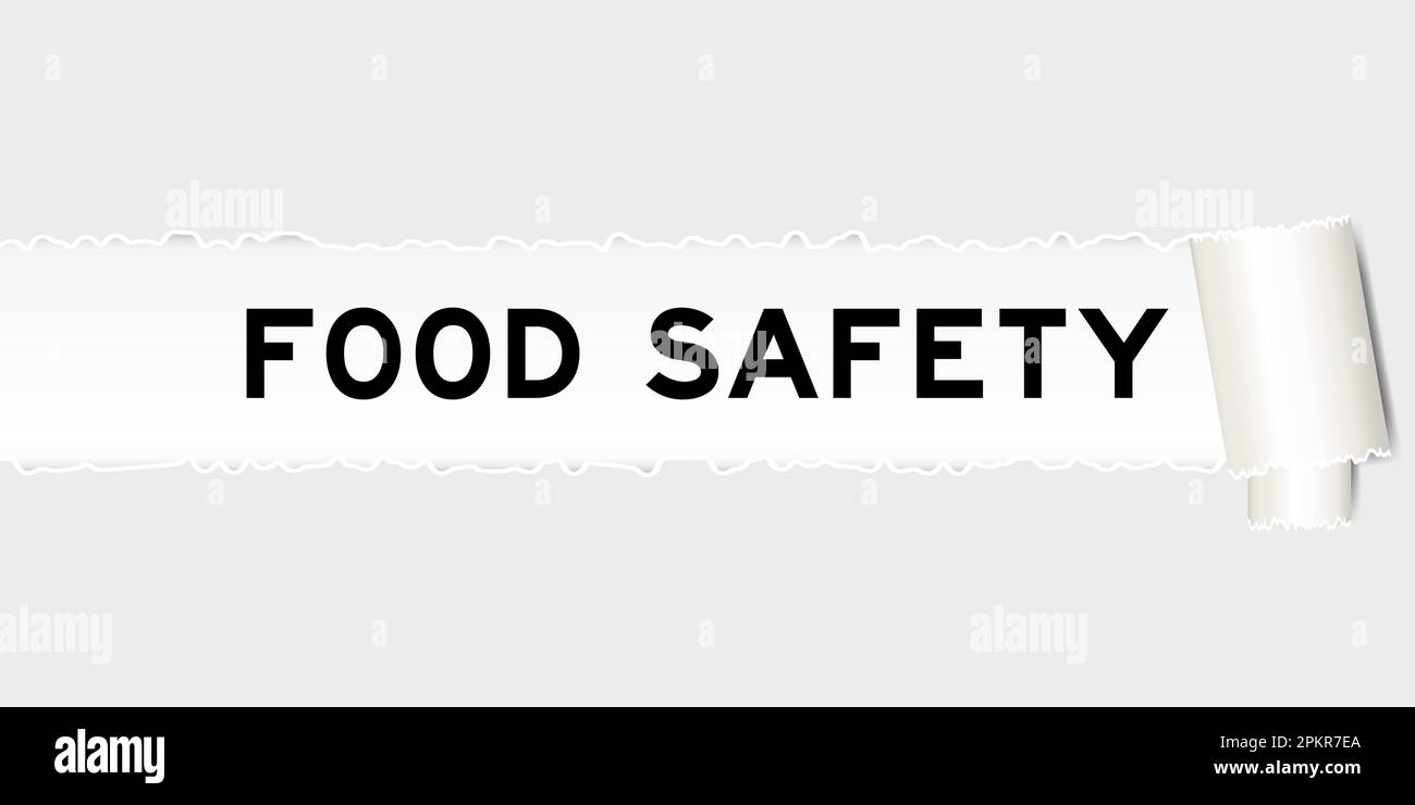 Ripped gray paper background that have word food safety under torn part ...