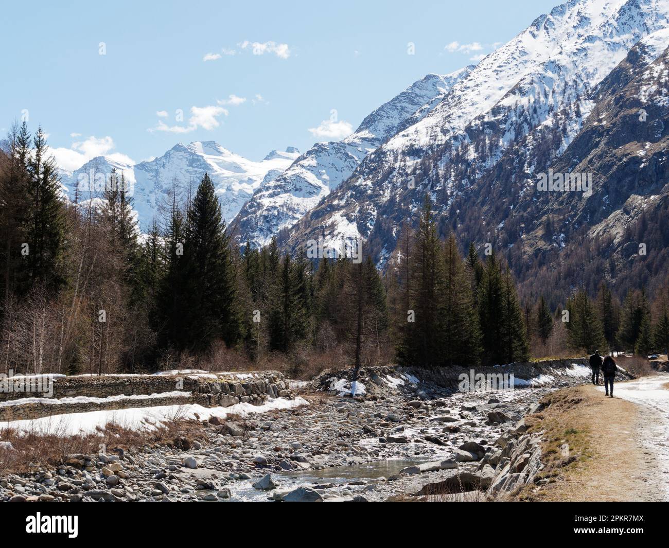 River runs through snow covered mountains and scenery near Valnontey ...
