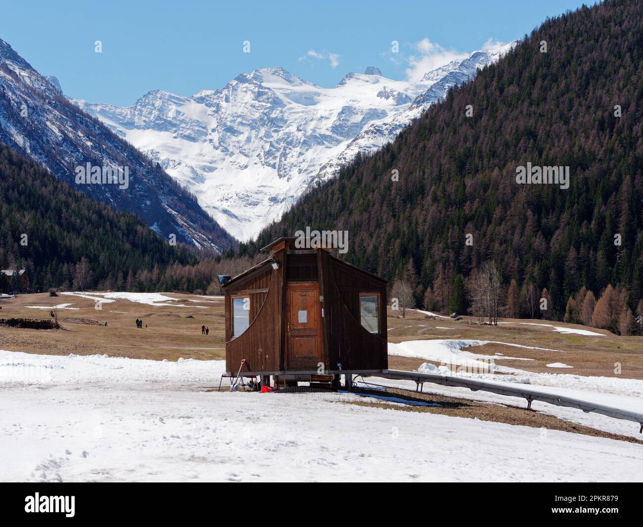 Wooden hut with mountain and forest behind in Cogne in springtime, Gran ...