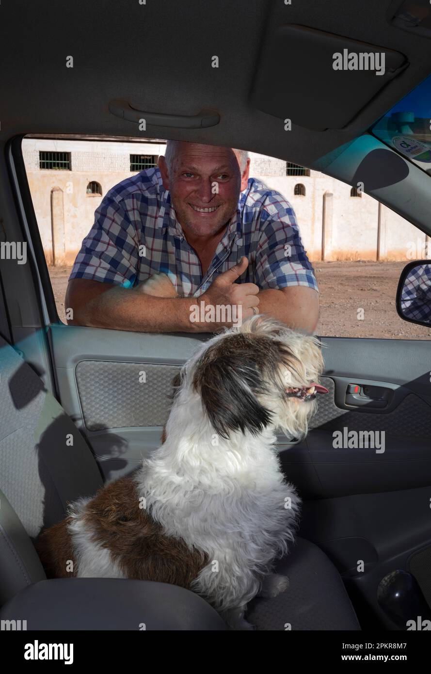Dairy farmer Eddie Schöder with his dog called ‘Spy’ in the village of ...