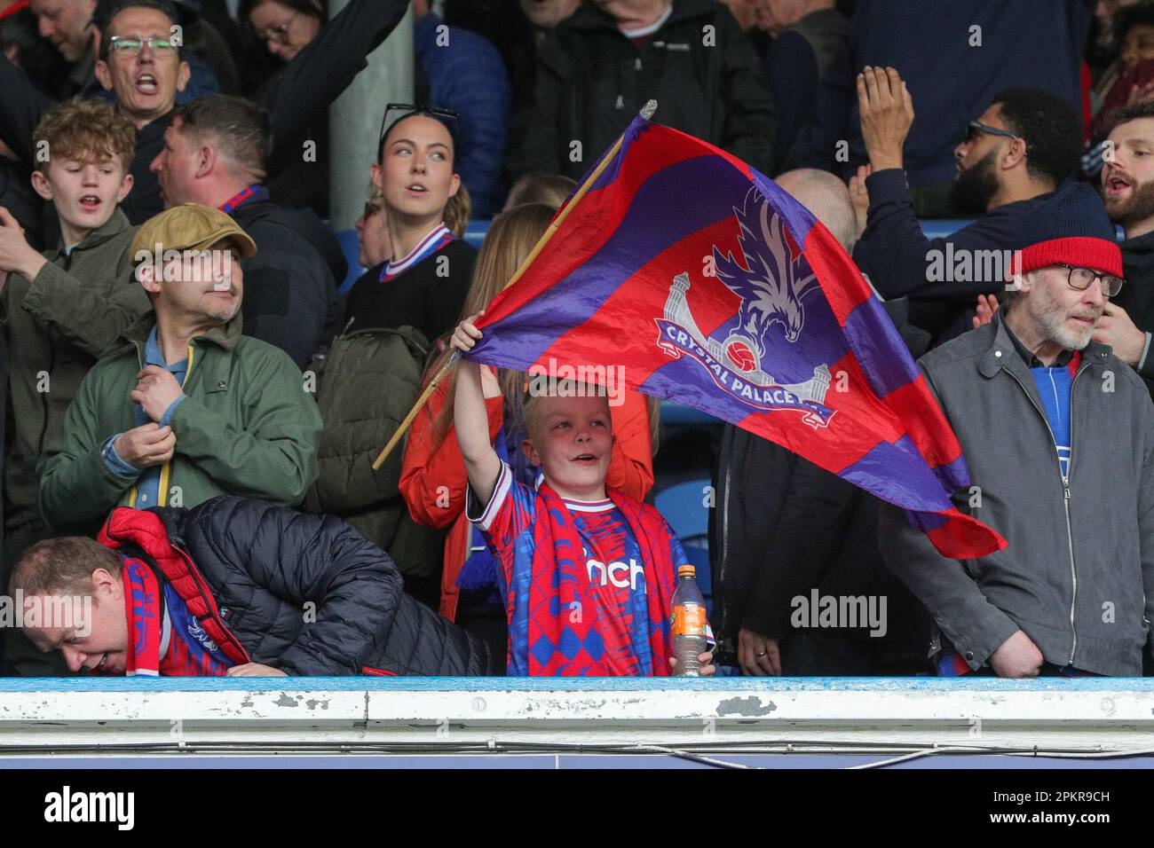 A young Crystal Palace fan waves a flag after his teams win in the ...