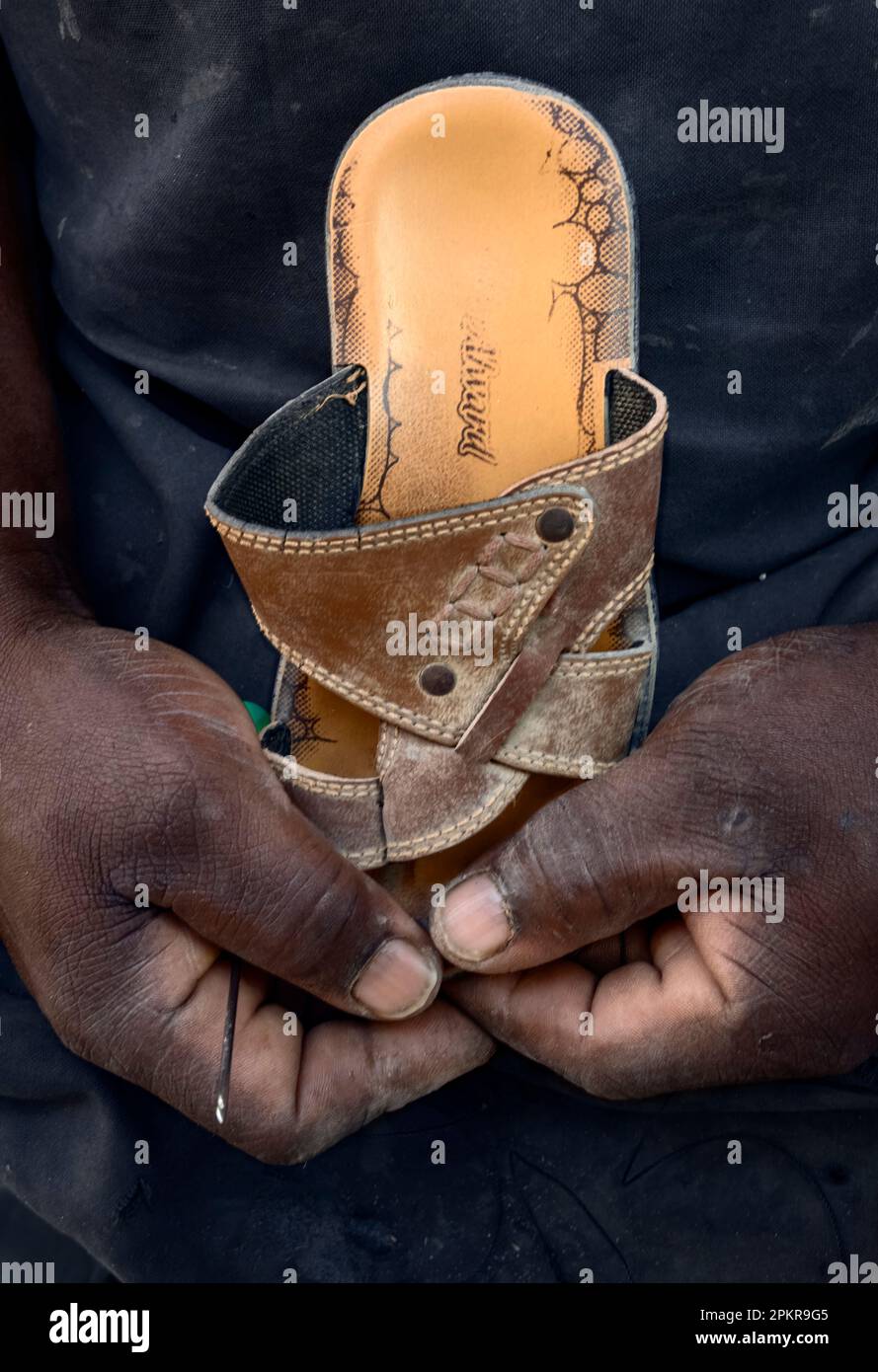 The shoemaker of Shela Town on the Island of Lamu Stock Photo - Alamy