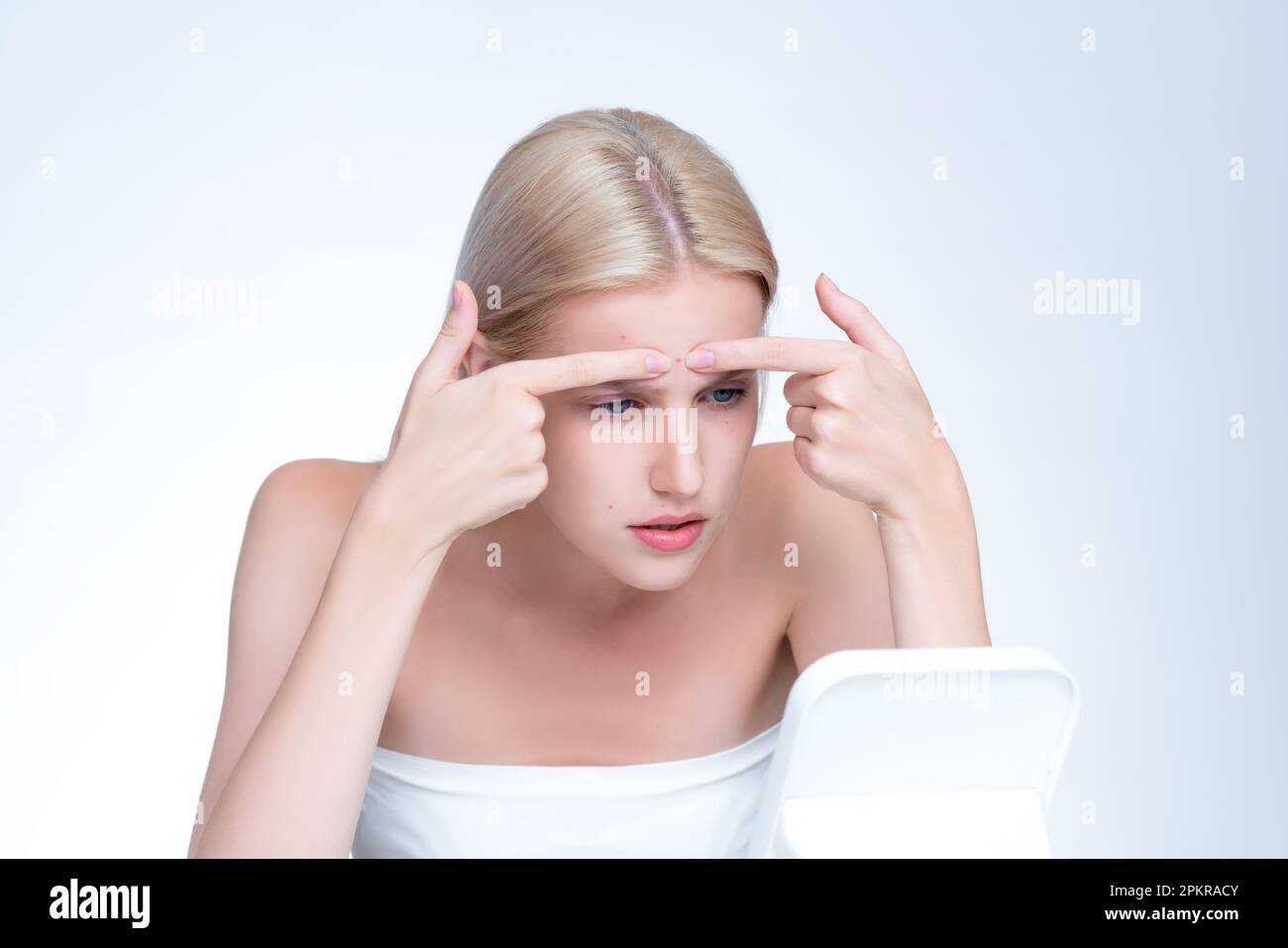 Woman squeezing spots hi-res stock photography and images - Alamy