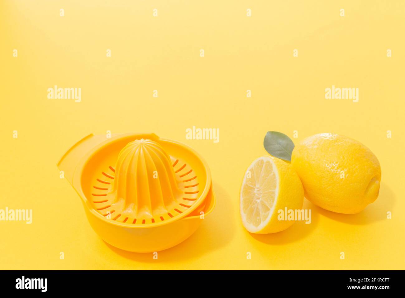 Lemons and yellow lemonade plastic strainer on yellow Background ...