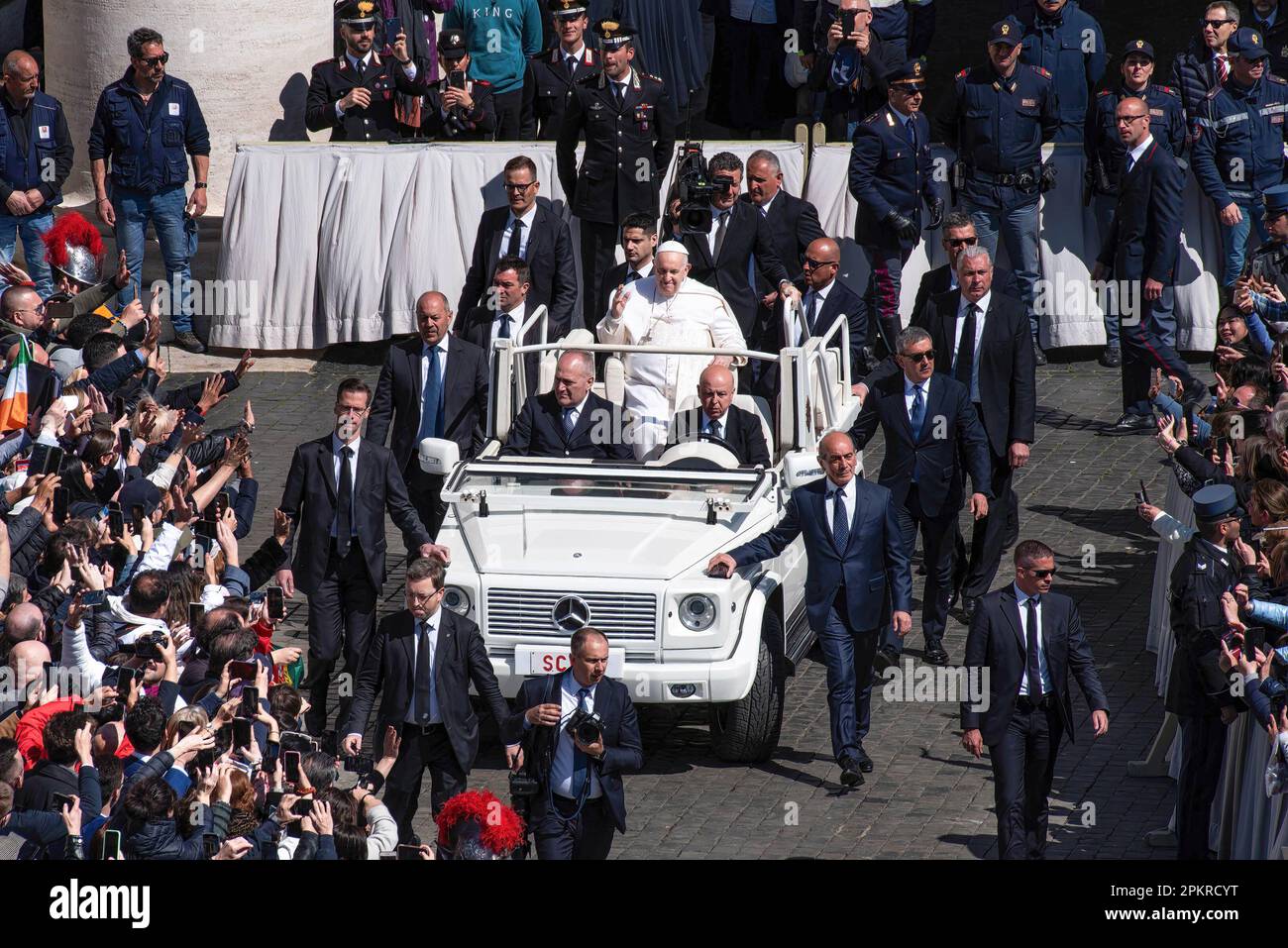 Pope Francis walks down one of the corridors of St. Peter's Square ...