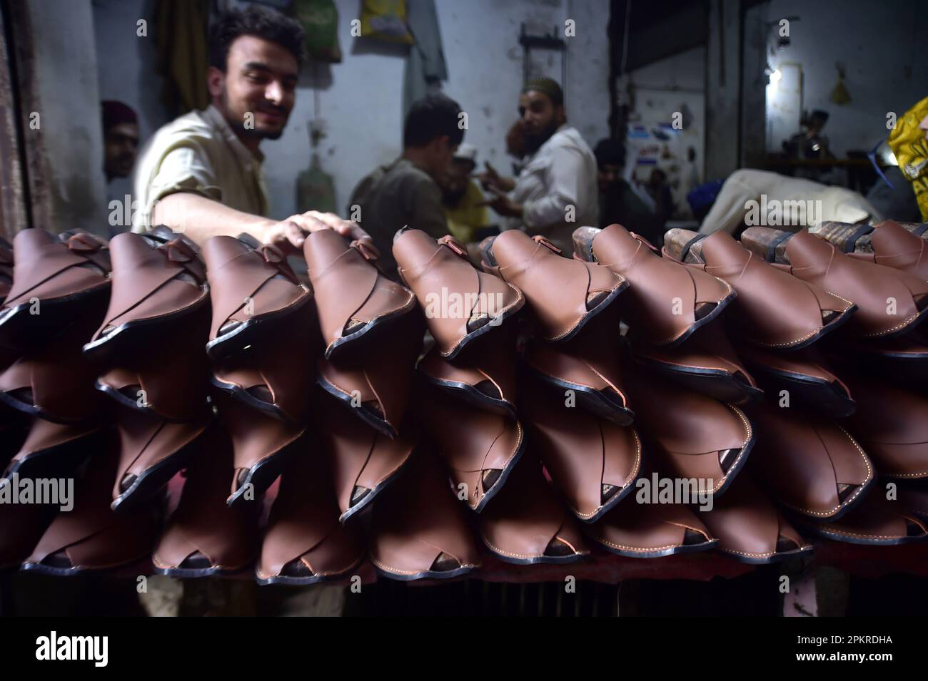 Peshawar, Pakistan. 9th Apr, 2023. A Pakistani shoemaker arranges ...