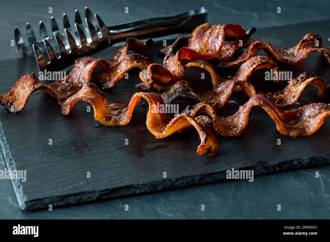 Crispy wavy maple peppercorn bacon, ready for eating Stock Photo - Alamy