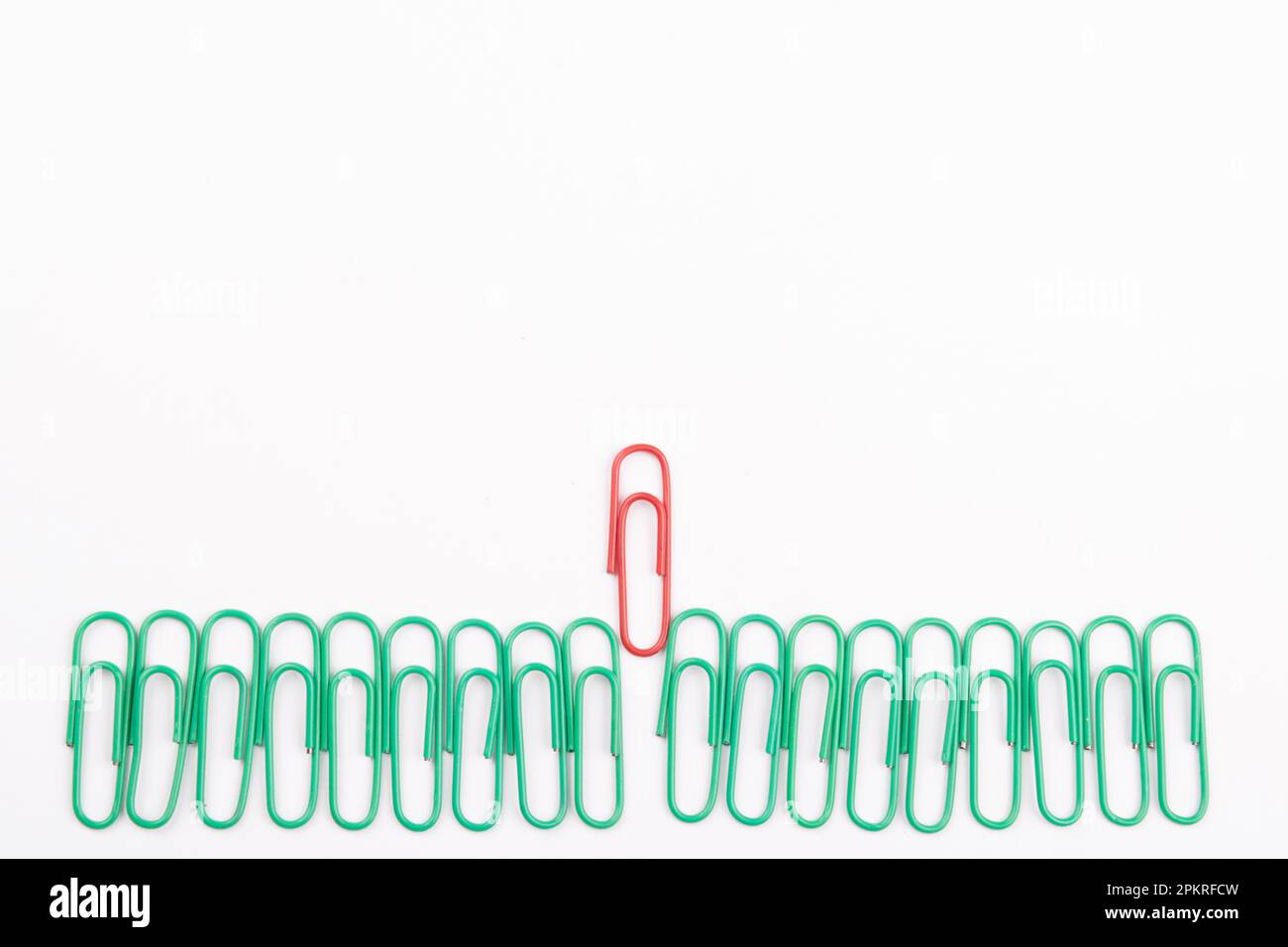 One red paperclip with all green paperclip leadership concept Stock ...