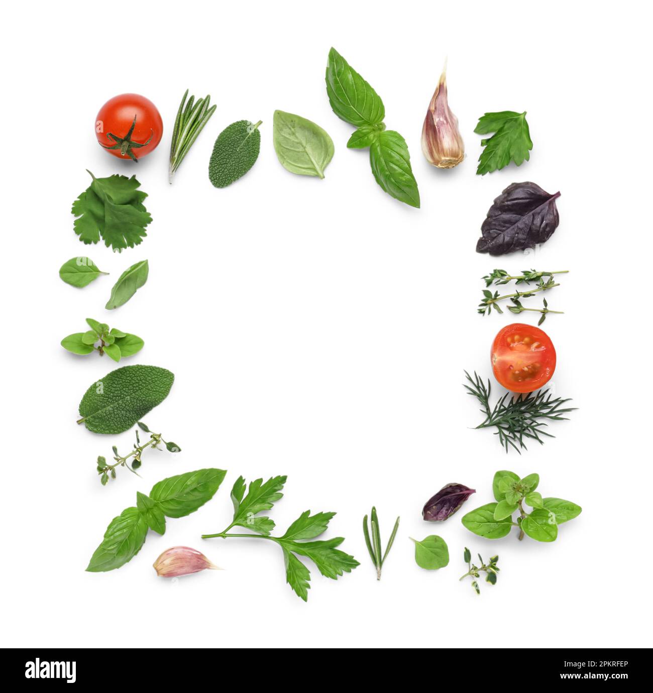 Frame made of fresh herbs, garlic and tomatoes on white background ...