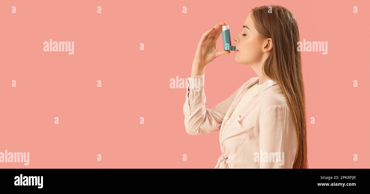 Sick young woman using inhaler on pink background with space for text ...