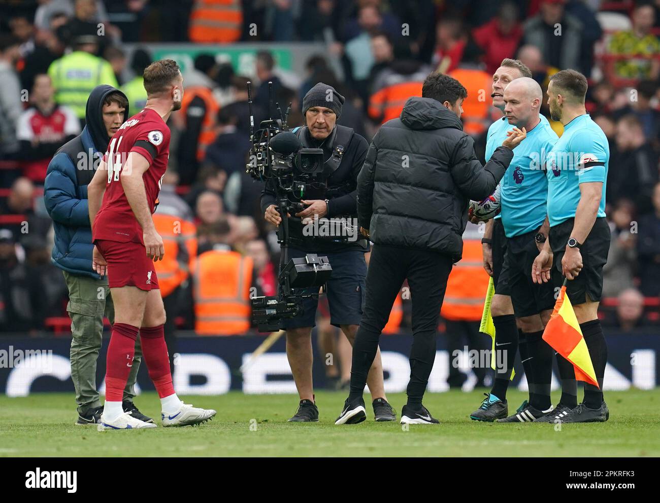Liverpool's Jordan Henderson speaks with assistant referee Scott Ledger ...