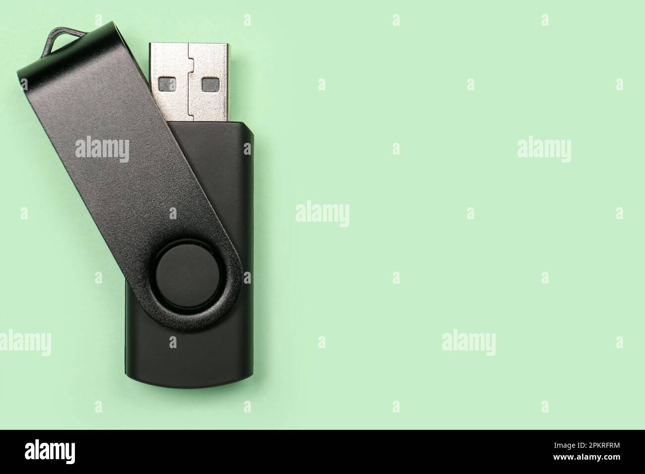 Black USB flash drive on green background Stock Photo - Alamy