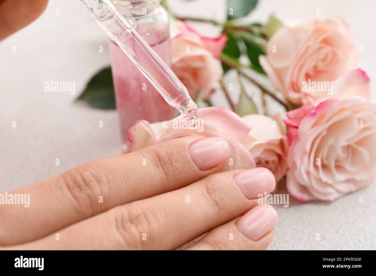 Woman applying oil onto cuticles on light background, closeup Stock ...