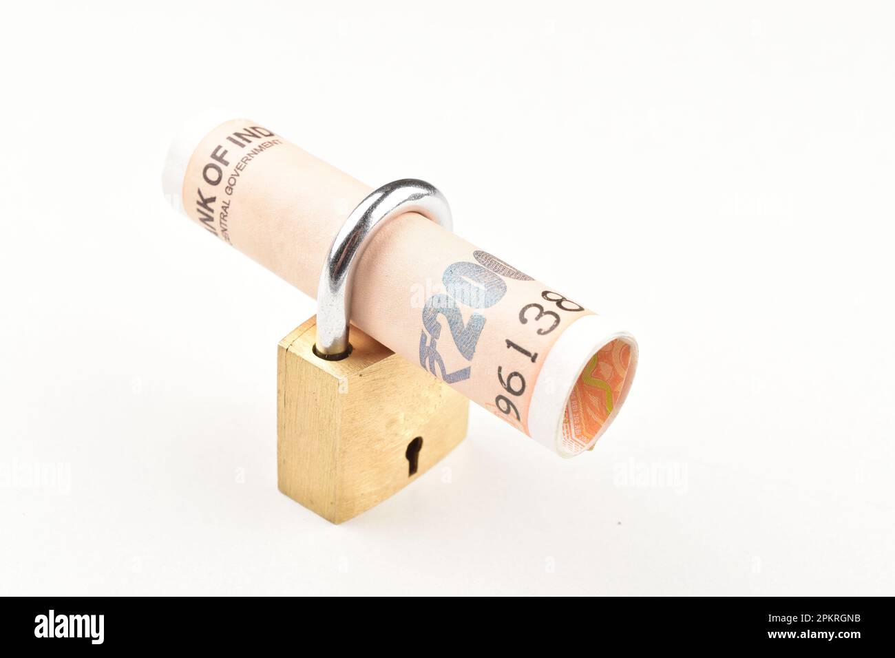 Indian currency with lock on white background Stock Photo - Alamy