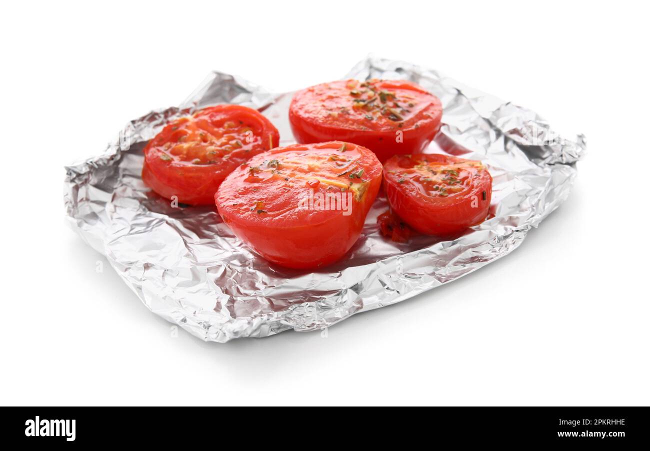 Aluminium foil with tasty baked tomatoes on white background Stock ...