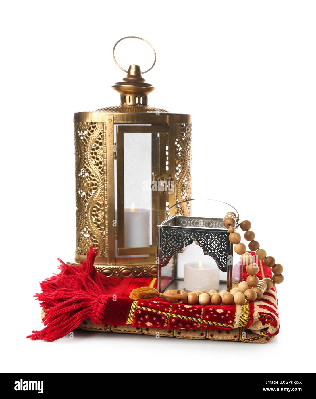 Muslim lamps with burning candles, prayer beads and mat on white ...